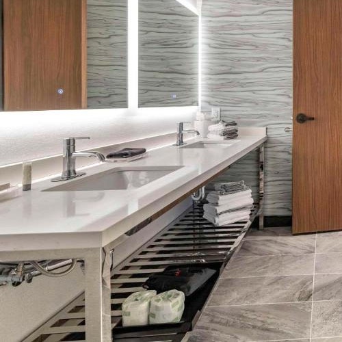 Metal vanity base with quartz surface in Cambria hotel
