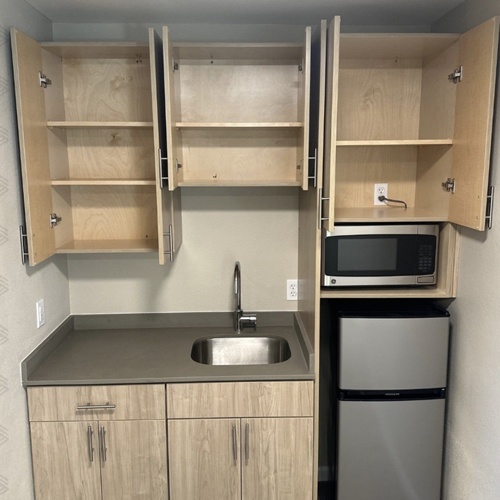 small linear kitchen assisted living wood cabinetry and quartz countertop